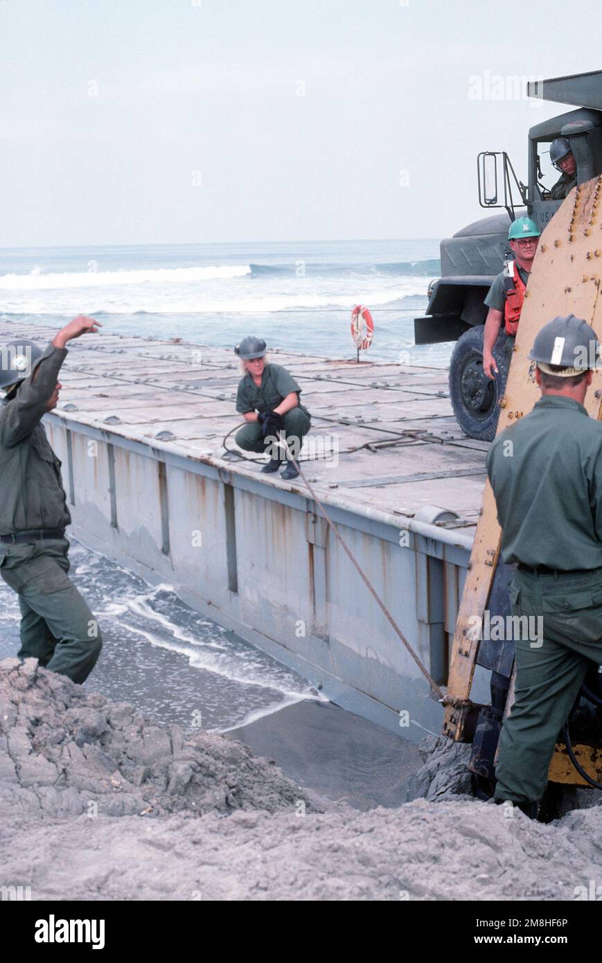 Steelworker Constructionman Erica Goldman hauls on a line attached to a ...