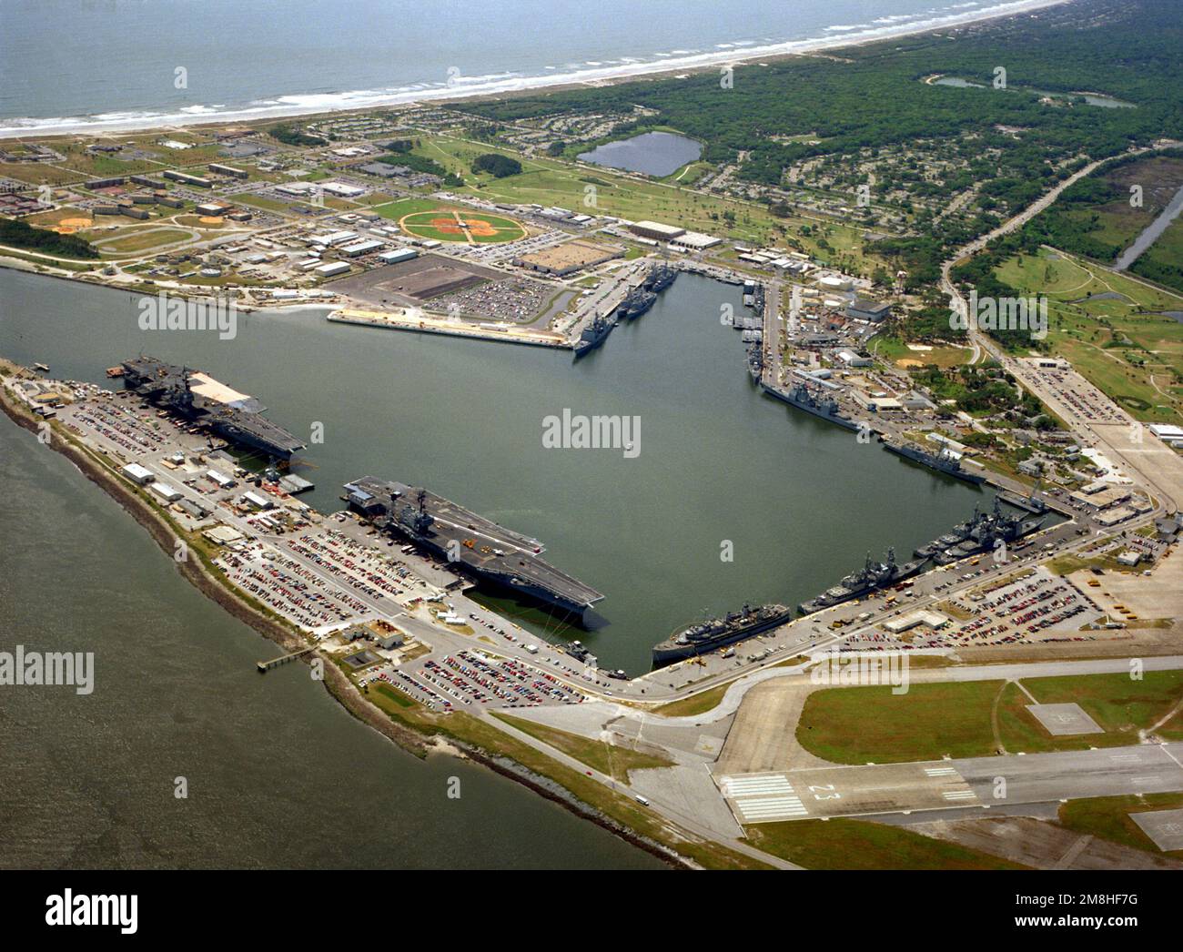 An aerial view of the naval station showing the aircraft carrier USS ...