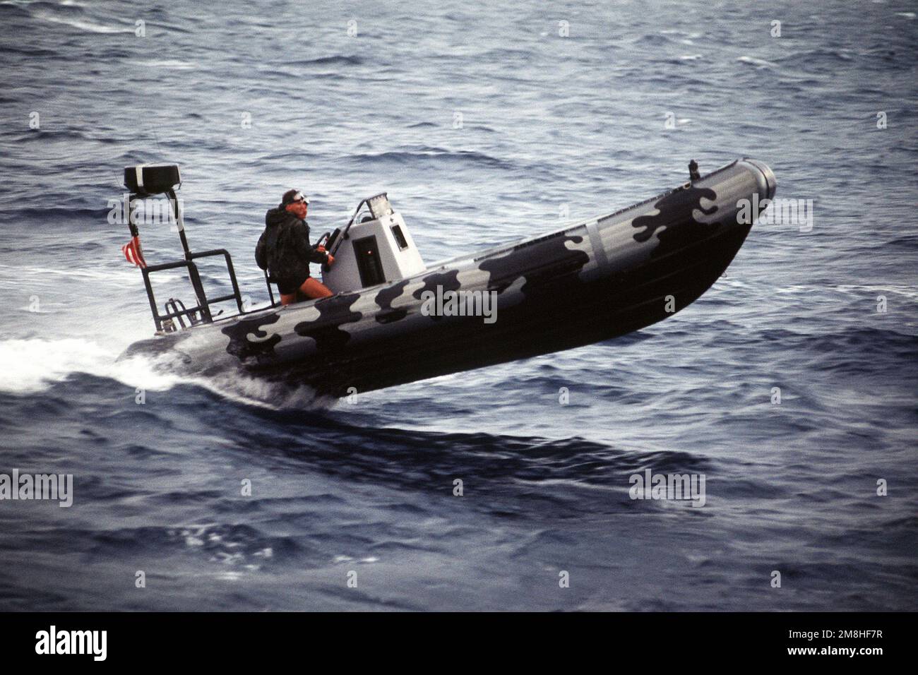 Members of Special Boat Unit 4 (SBU-4) operate a rigid-hull inflatable ...