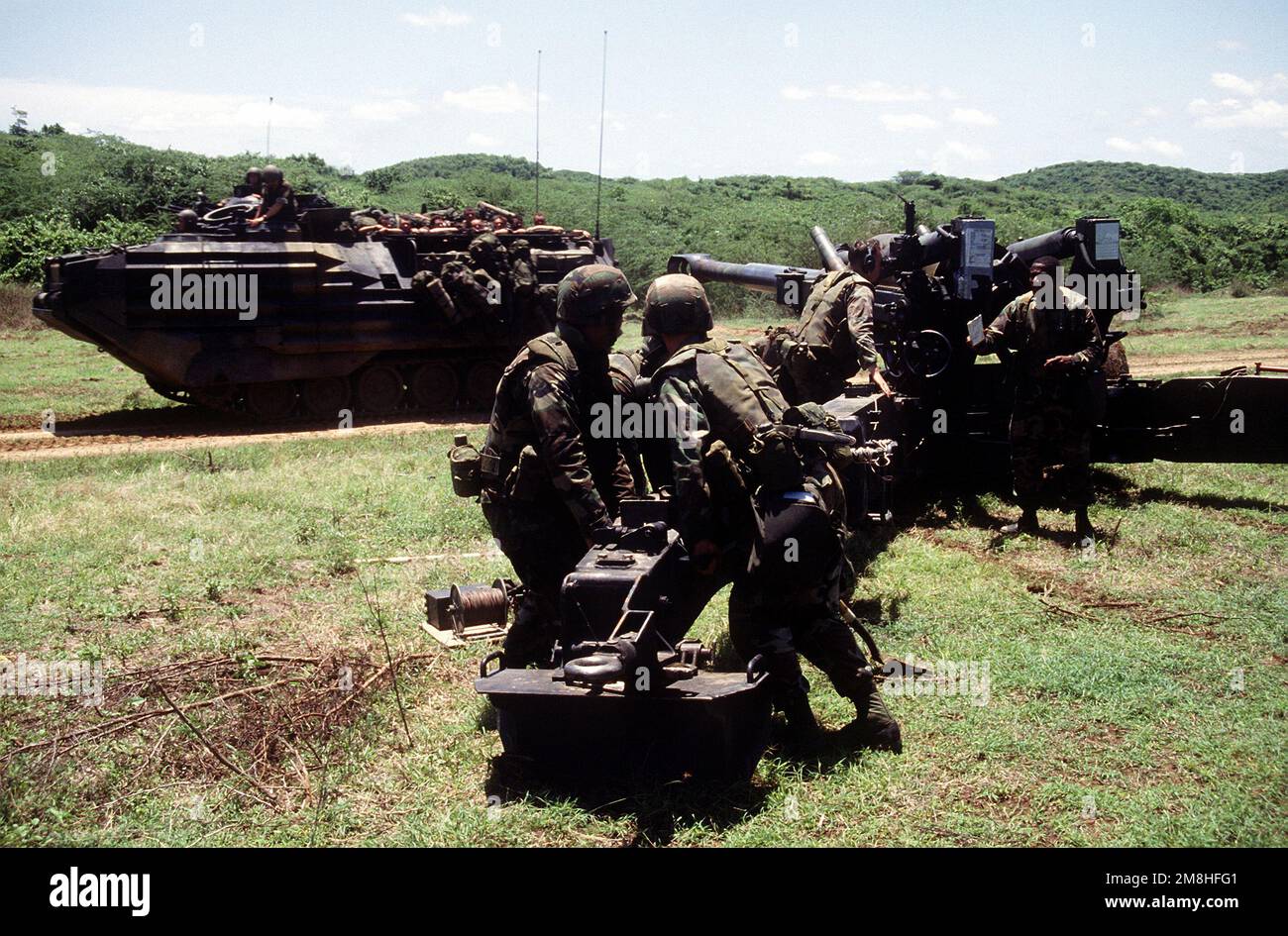 Members of Btry. R, 5th Bn., 10th Marine Regt., position the trails of ...