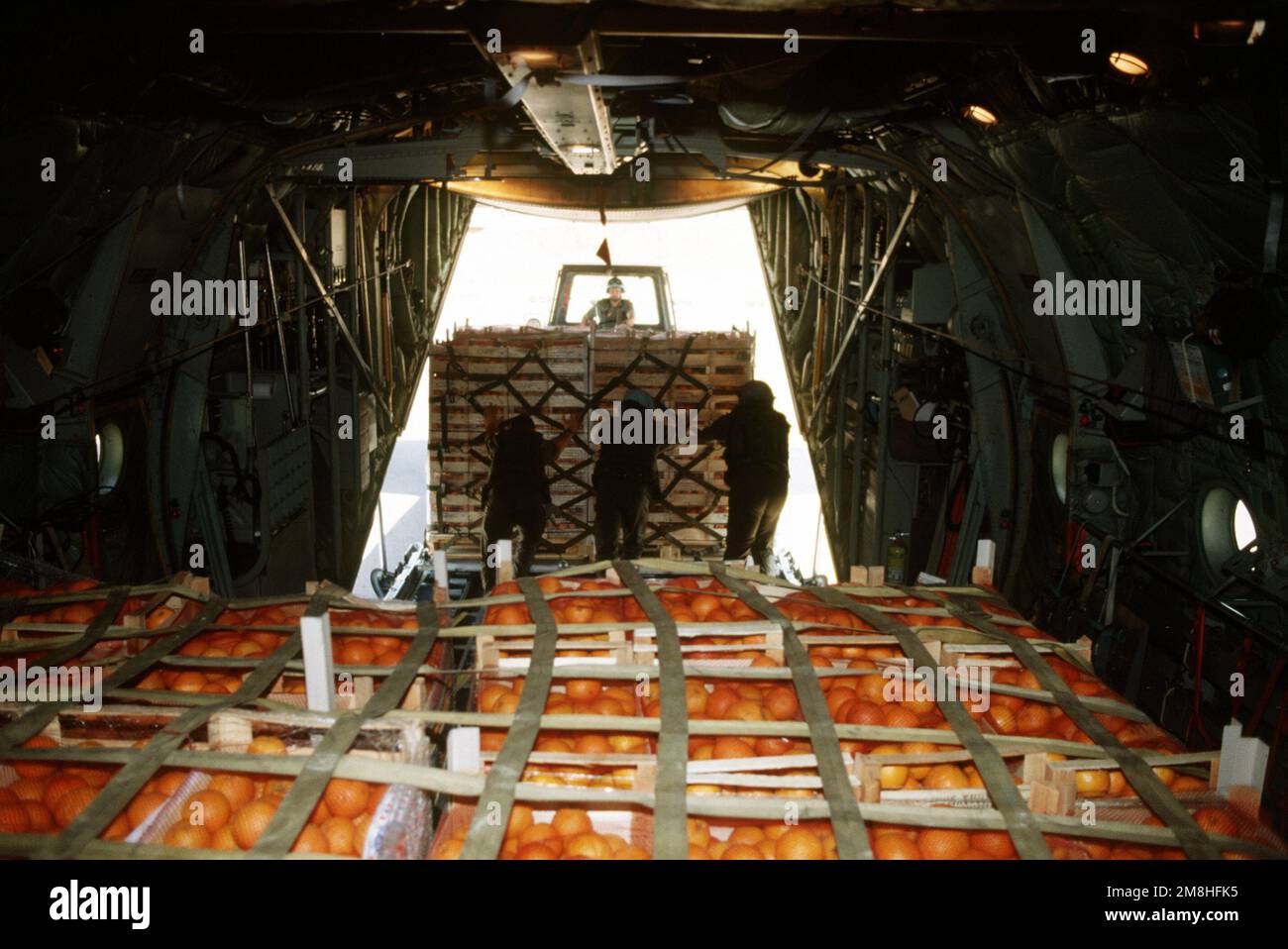 United Nations soldiers push pallets of food and relief supplies for ...