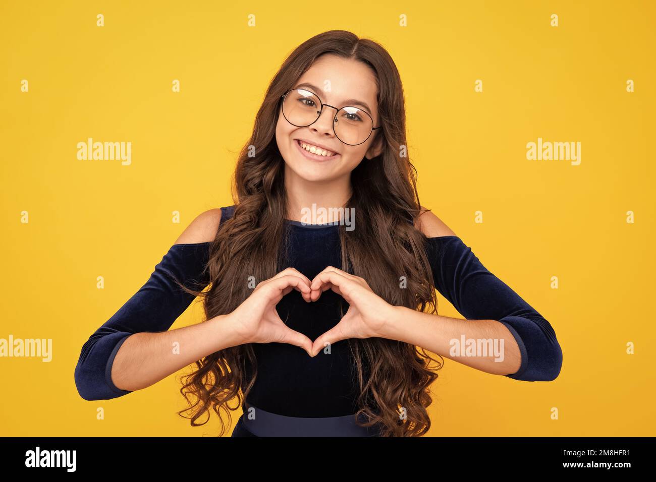 Child hands making sign heart by fingers. Lovely romantic teenage girl ...