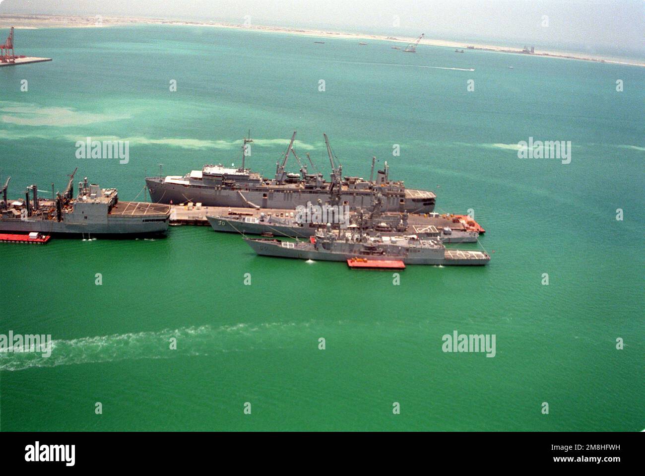 An aerial view of various U.S. Navy ships moored at the Mina Sulman ...