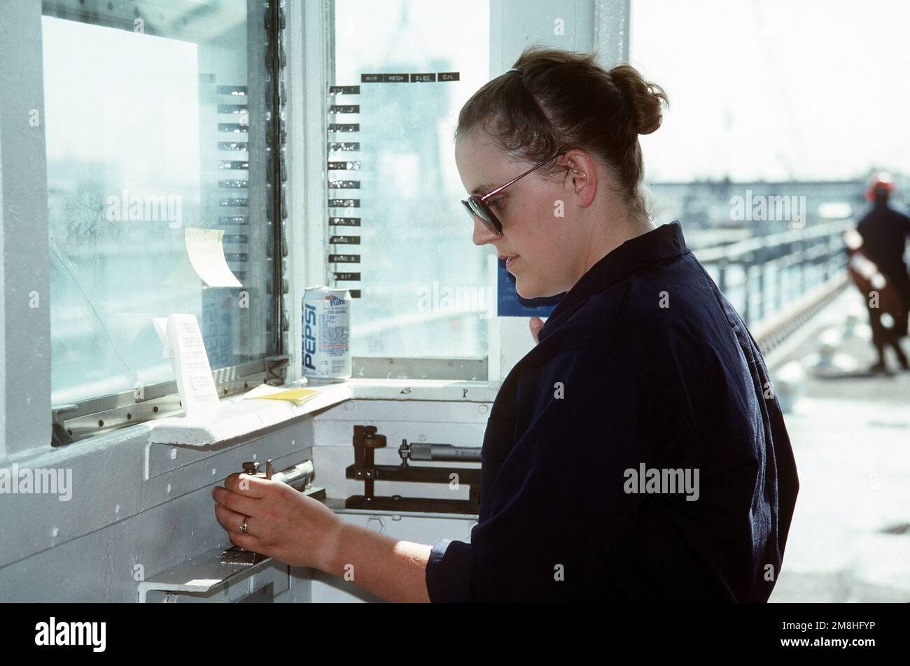 Storekeeper 2nd Class Nancy Underwood monitors the list and trim reader ...