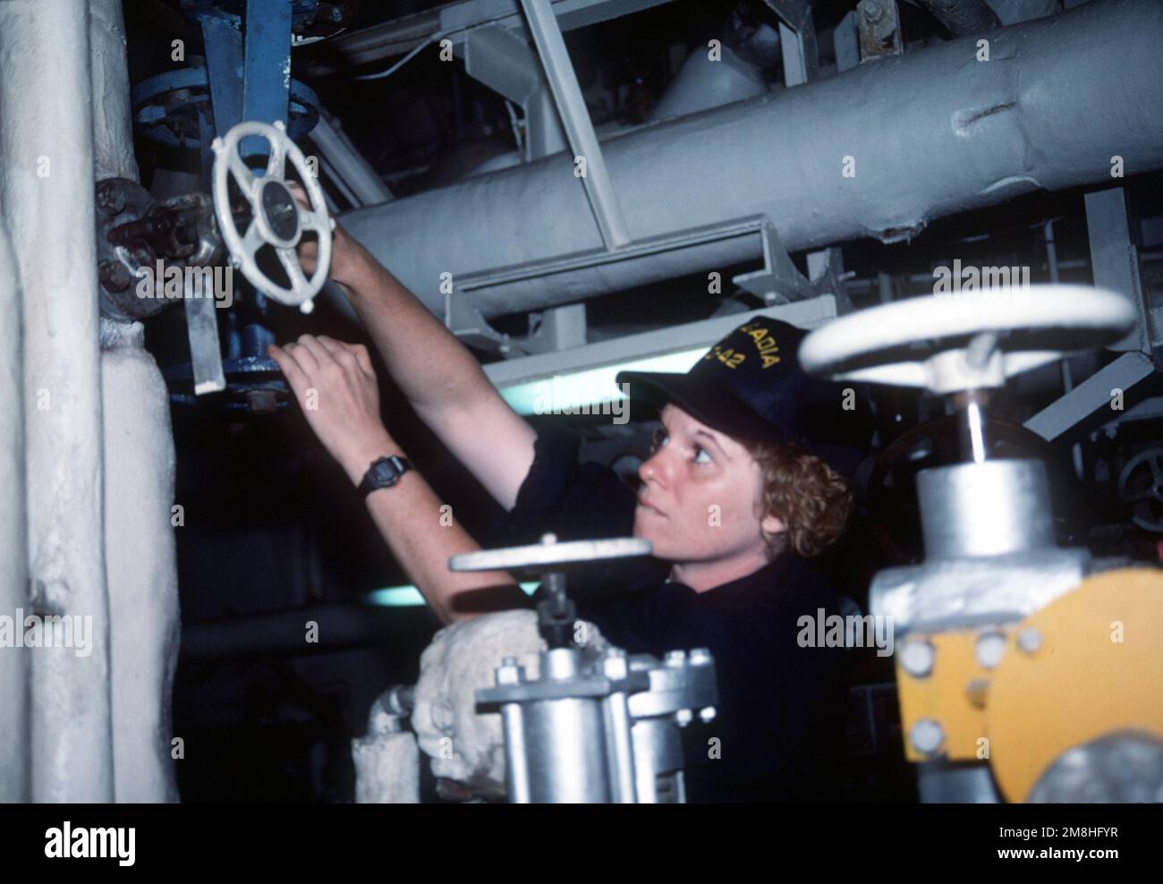 Boilerman Technician/Fireman Rebecca Powers turns a valve to maintain ...