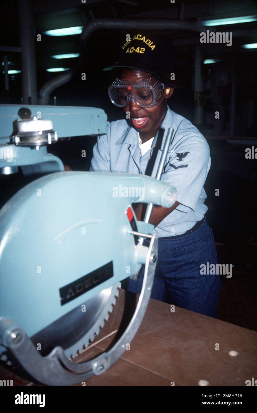 Patternmaker 3rd Class Marlene Sparks uses a radial arm saw to cut ...