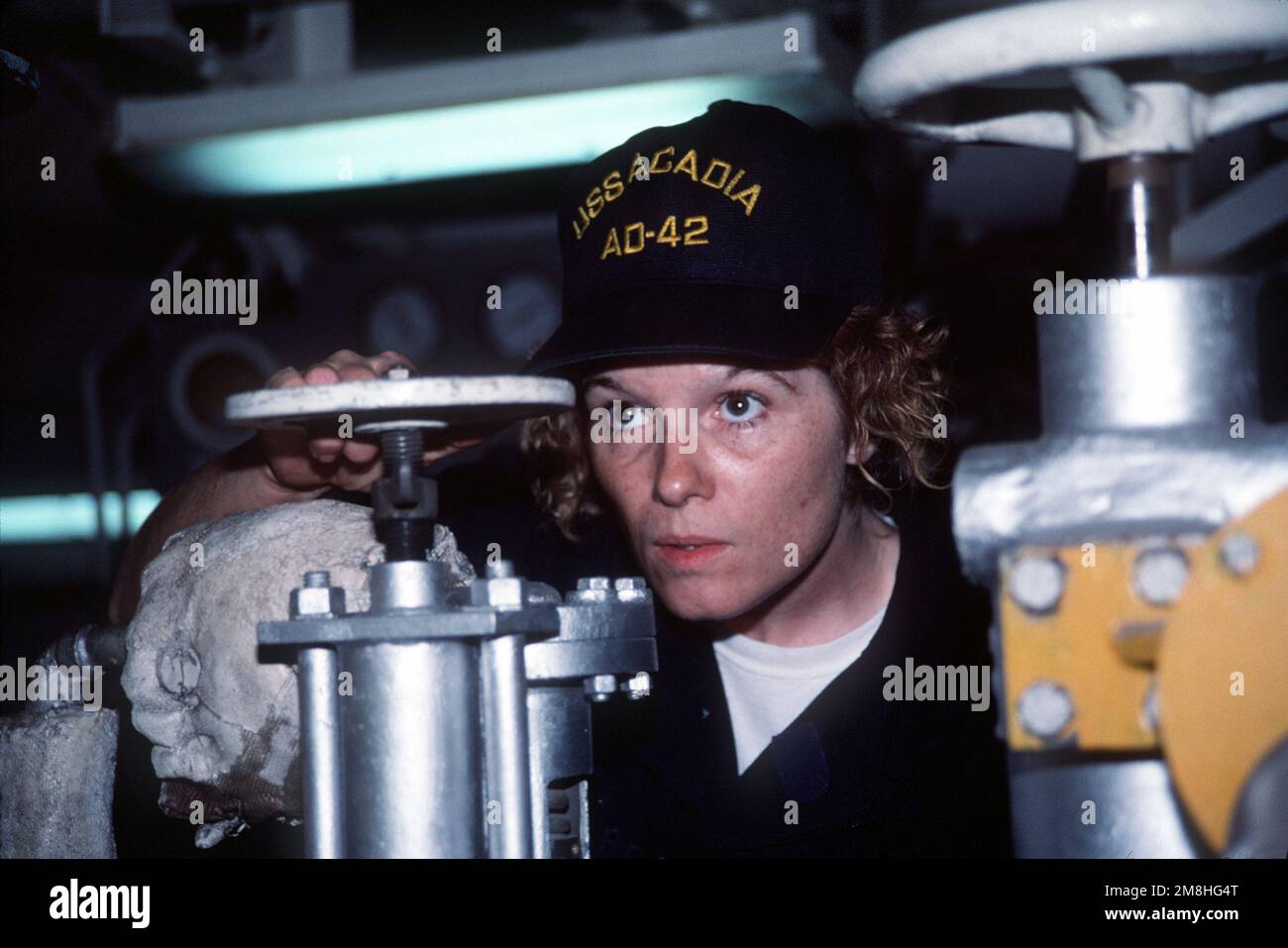Boilerman Technician/Fireman Rebecca Powers checks a valve to maintain ...