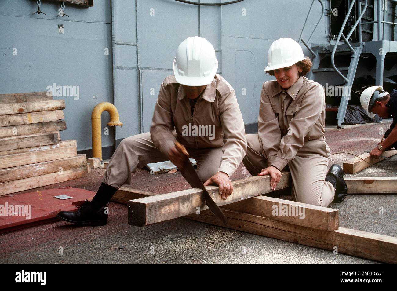 ENSIGN Robin Roch and other members of a damage control team place ...