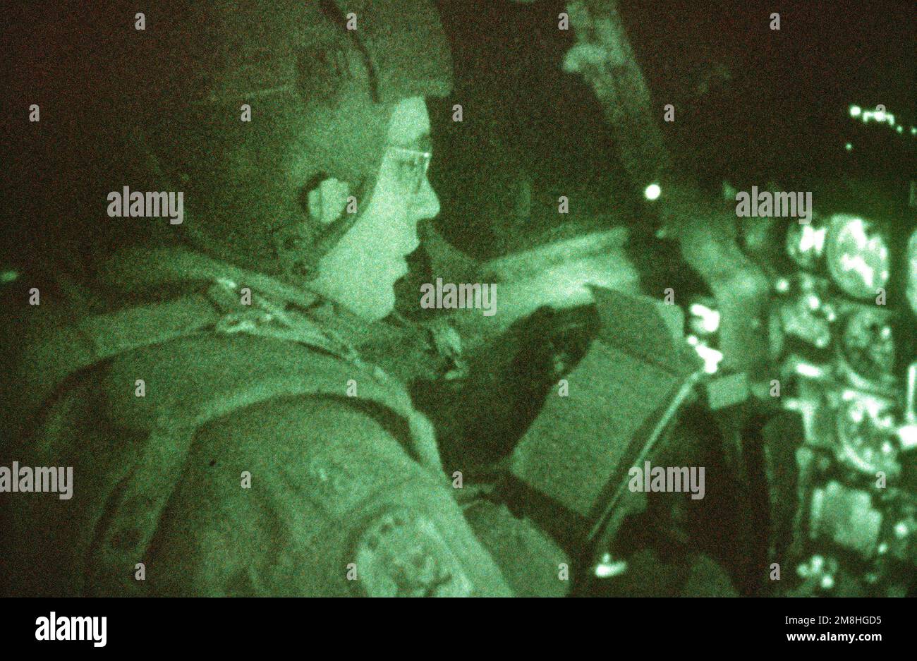 Night vision view of CPT Pat McLeod (left) pilot in the cockpit of a ...