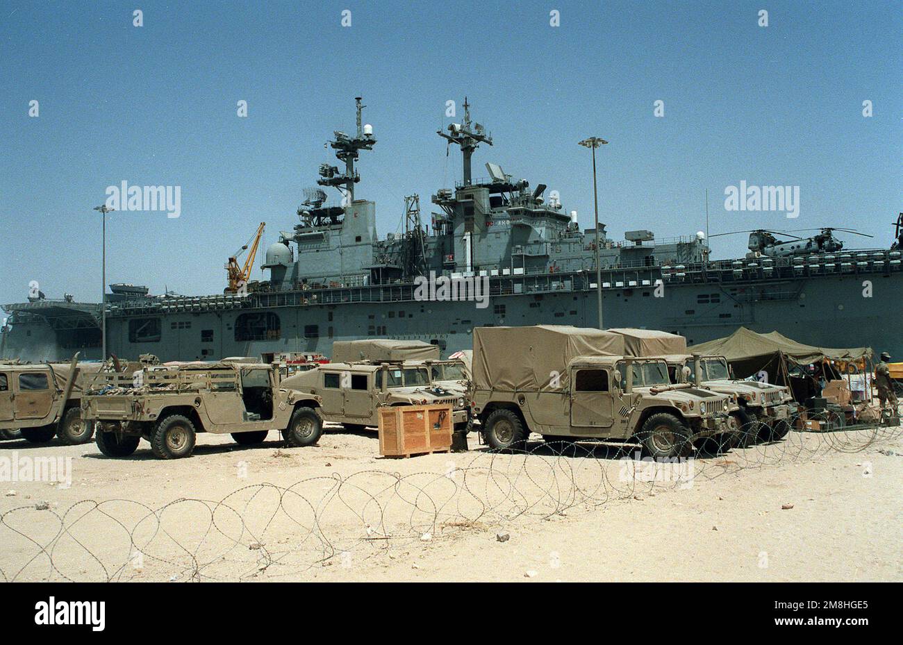 M998 High-Mobility Multipurpose Wheeled Vehicles (HMMWV) stand on the ...