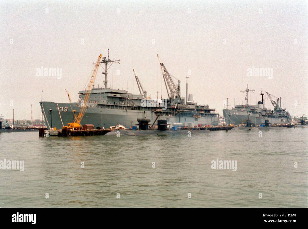 A port bow view of the submarine tenders USS EMORY S. LAND (AS-39) and ...