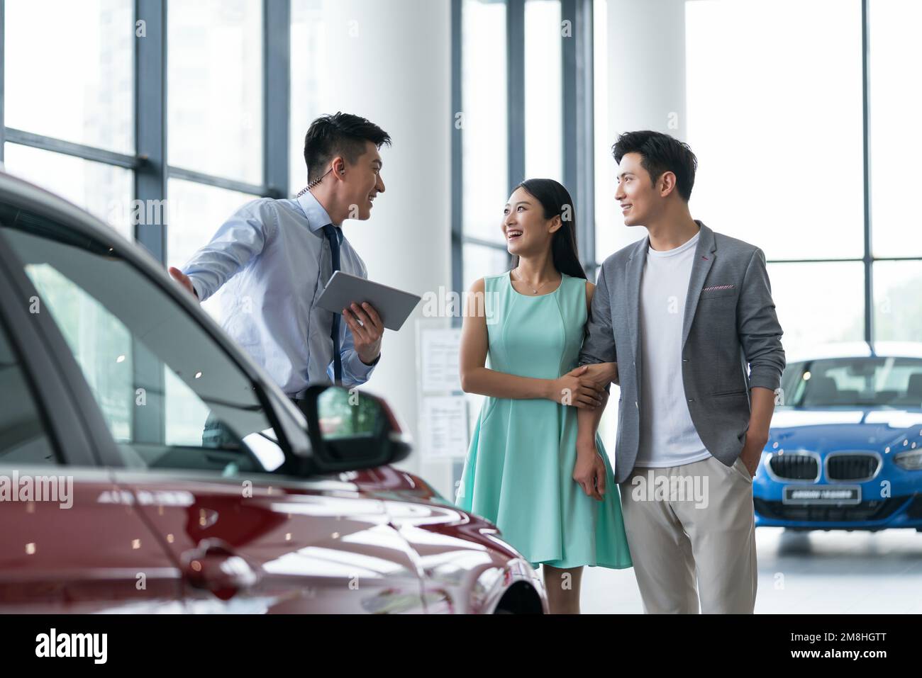 A young couple of choose and buy cars Stock Photo - Alamy