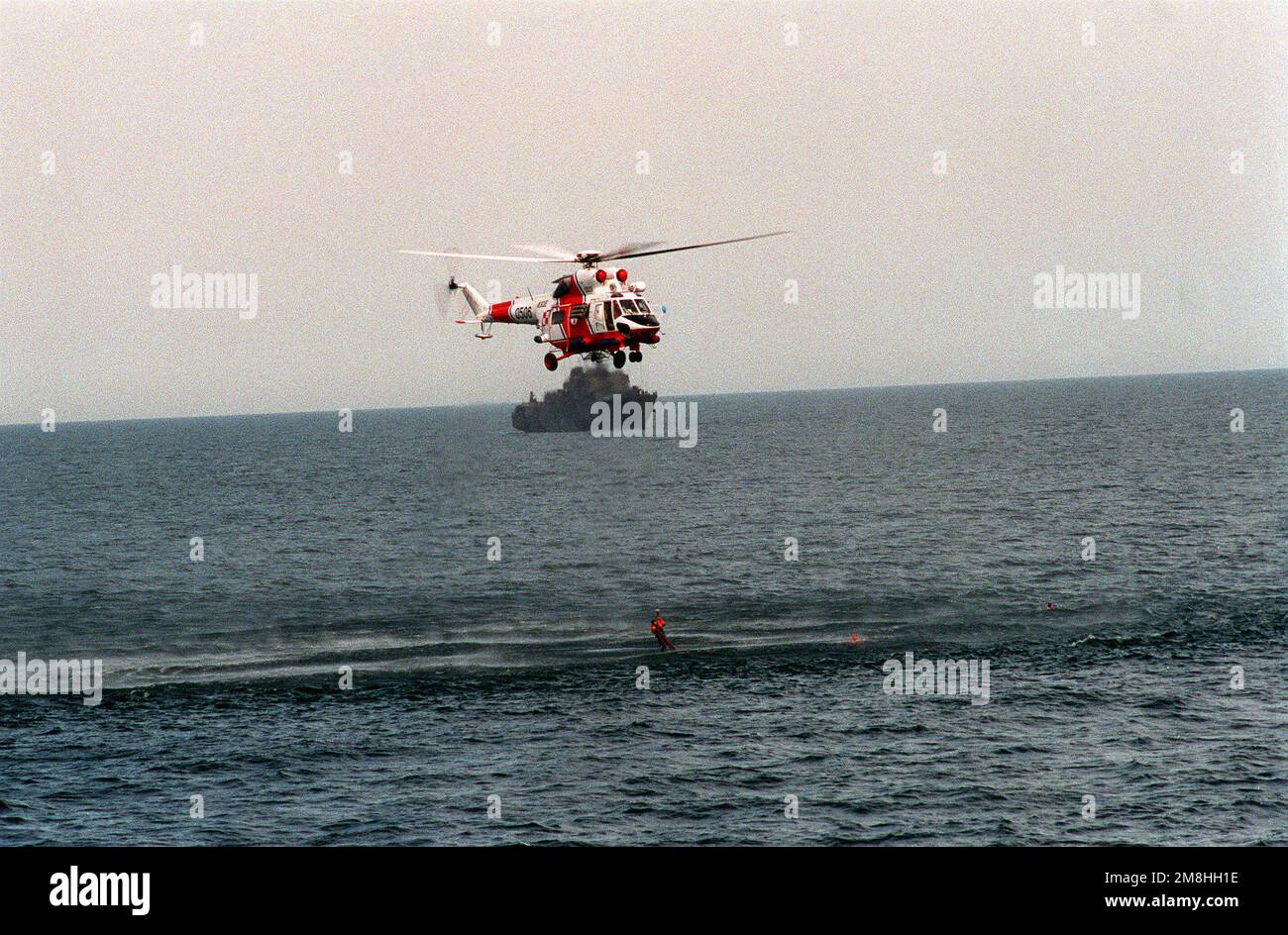 A Polish PZL Swidnik W-3 Sokol helicopter hoists a swimmer out of the ...