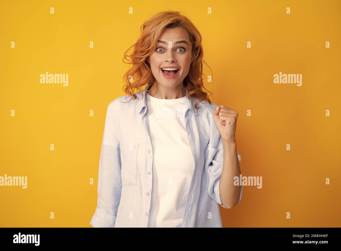 Cheerful beautiful young woman showing winner gesture. Girl celebrating ...