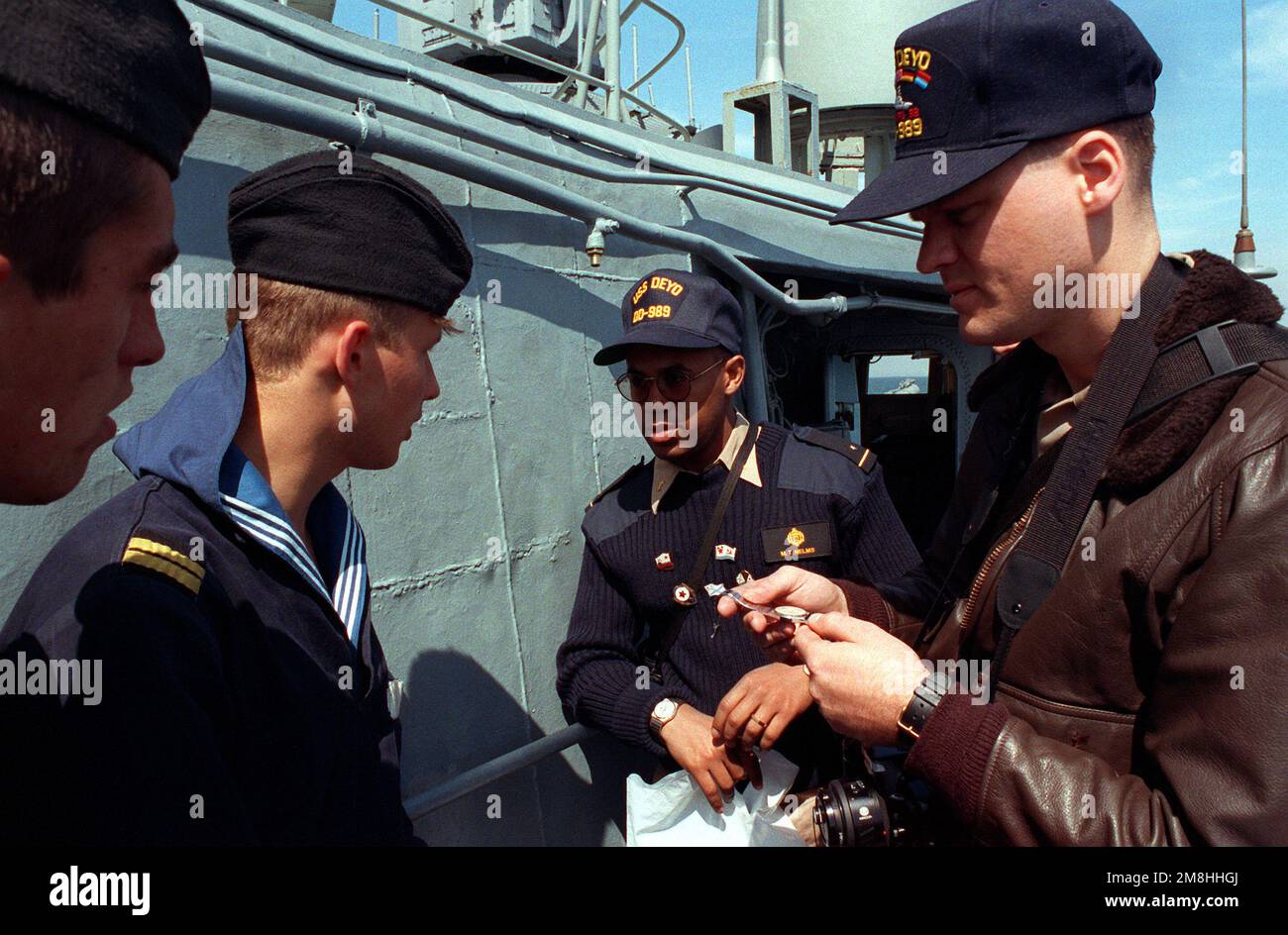 Midshipman 1ST Class Michael Nelms, center, serves as an interpreter ...