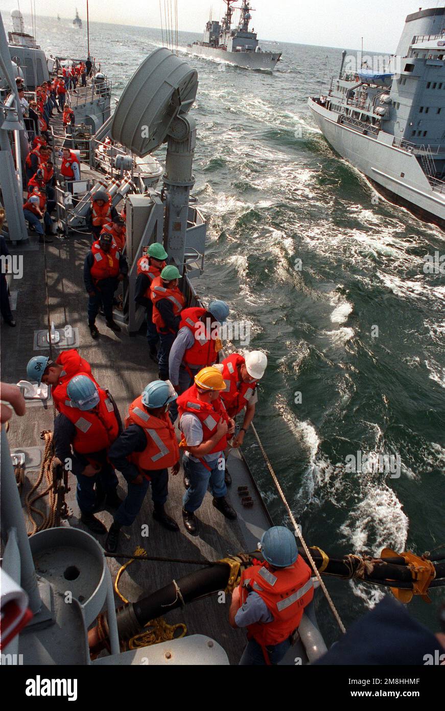Crewmen stand by on the guided missile frigate USS DOYLE (FFG-39) while ...