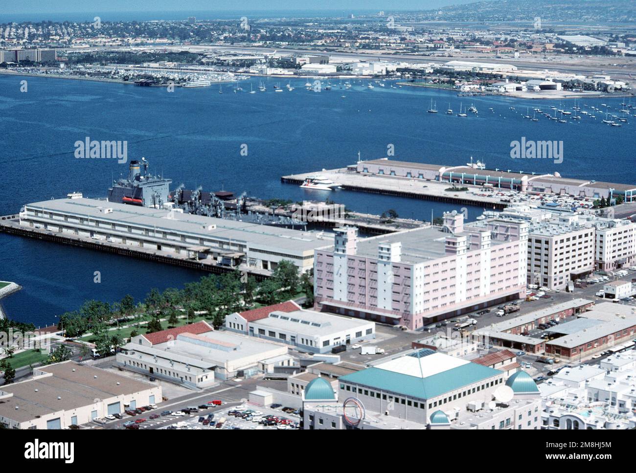 A Military Sealift Command Henry J. Kaiser class oiler is moored to a ...