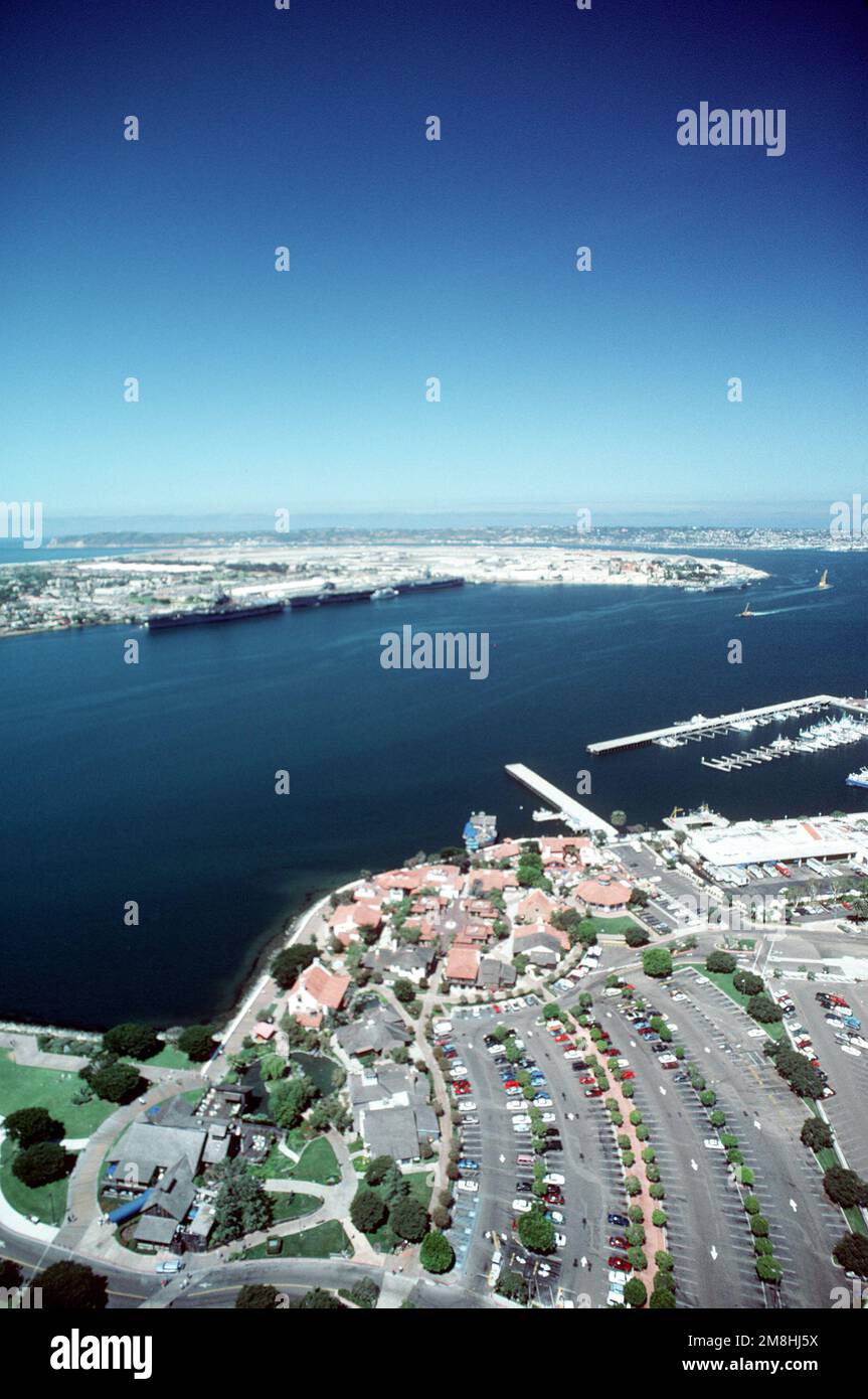 An overview of three carriers moored at the carrier pier at Naval Air ...