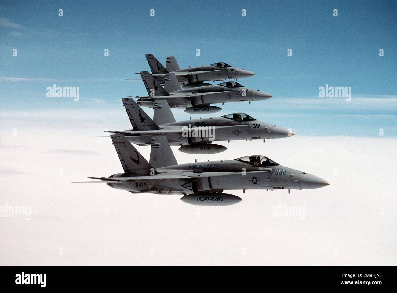 An air-to-air right side view of four Fighter Attack Squadron 136 (VFA ...