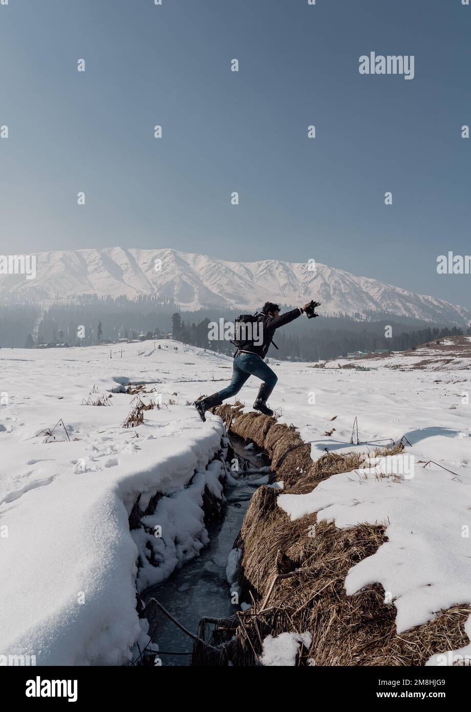 man jumping a ice hole in Jammu and Kashmir , India Stock Photo - Alamy