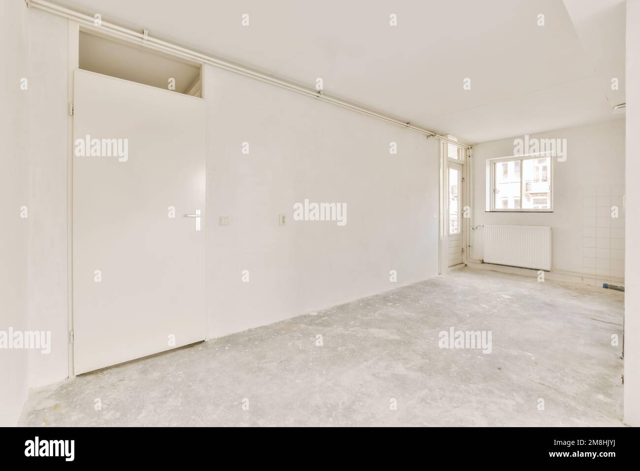 an empty room with white walls and no one door on the other wall there ...