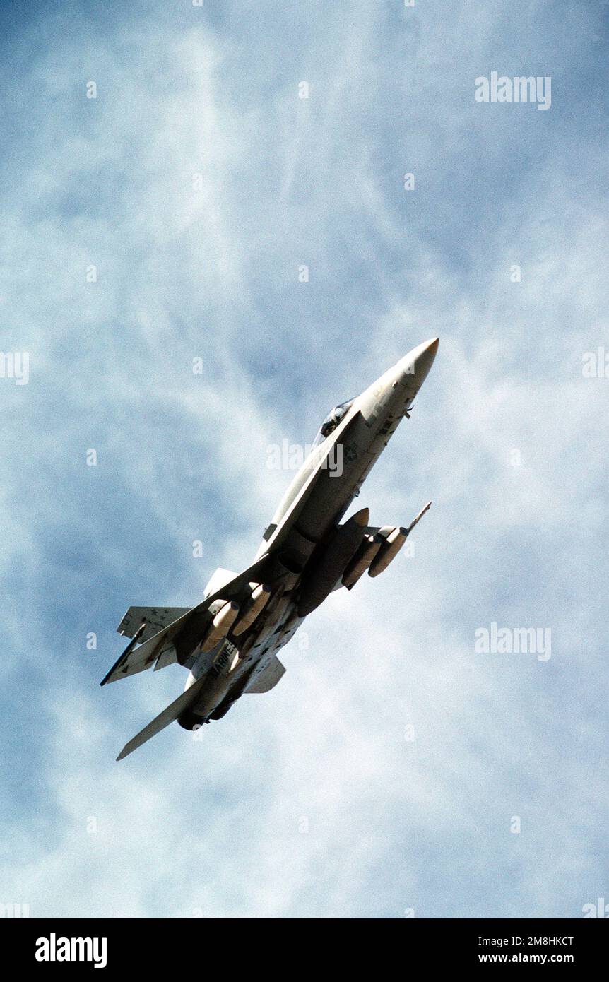 An in flight underside view of an F/A-18A Hornet aircraft of Marine ...
