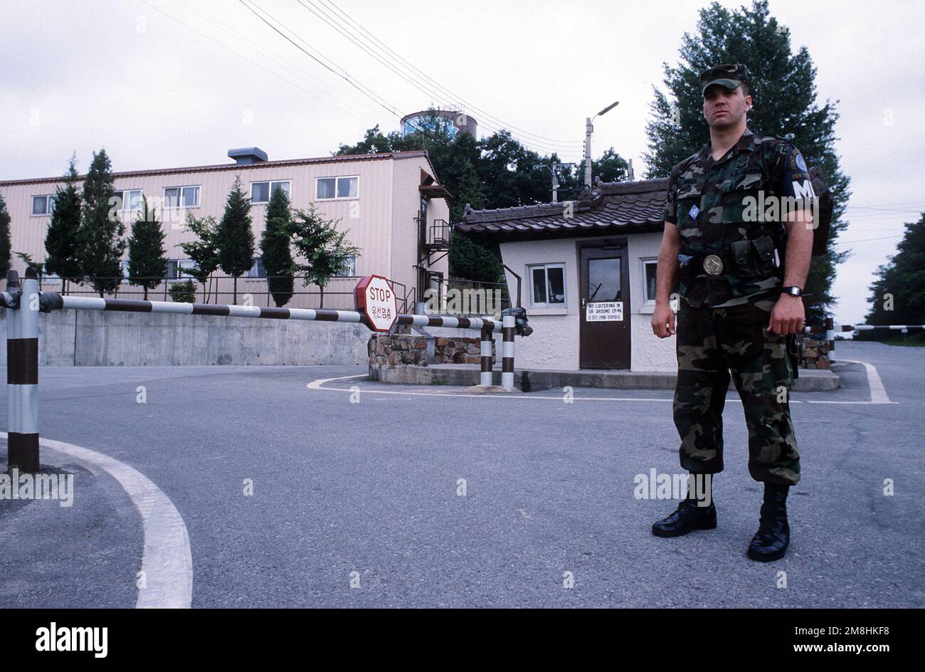 Army policeman, SPC. Matthew Kubes, guards the checkpoint alpha gate at ...