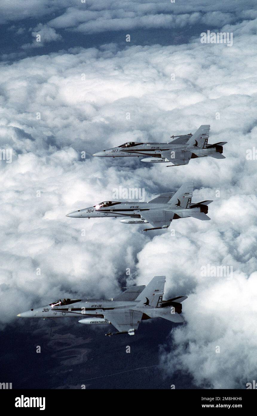 An air-to-air left side view of three Strike Fighter Squadron 136 (VFA ...