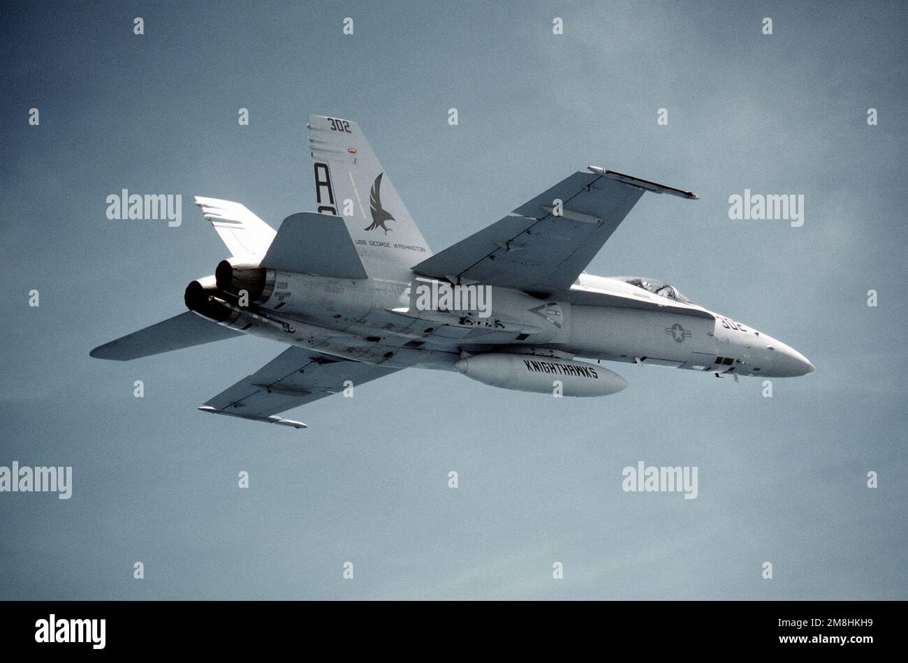 An air-to-air underside view of a Strike Fighter Squadron 136 (VFA-136 ...