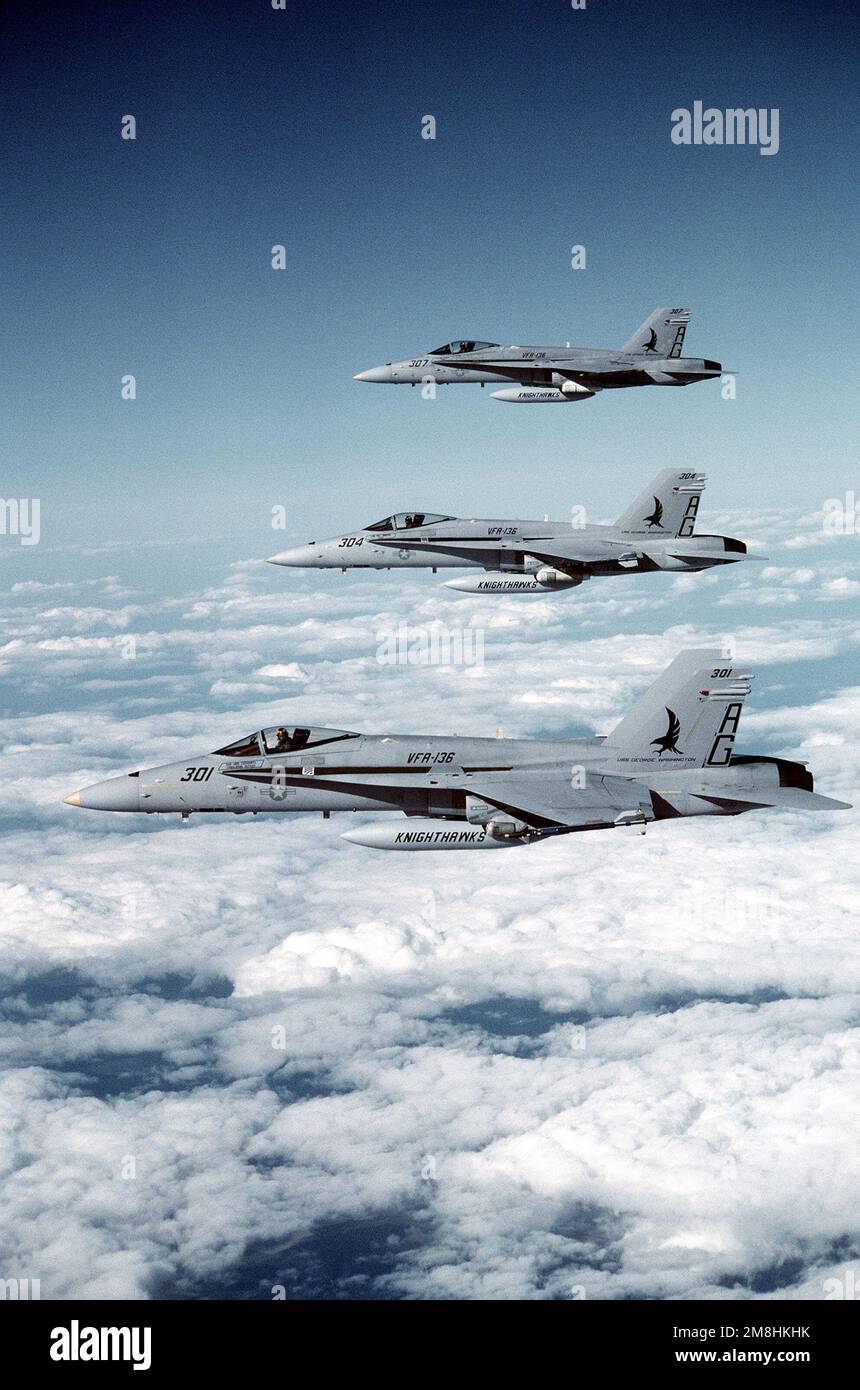 An air-to-air left side view of three Strike Fighter Squadron 136 (VFA ...