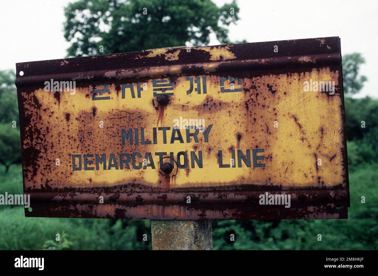 PHOTO of the Military Demarcation Line (MDL), sign located in the woods ...
