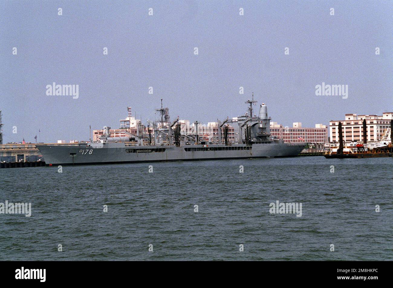 A port view of the fleet oiler USS MONONGAHELA (AO-178) moored to pier ...