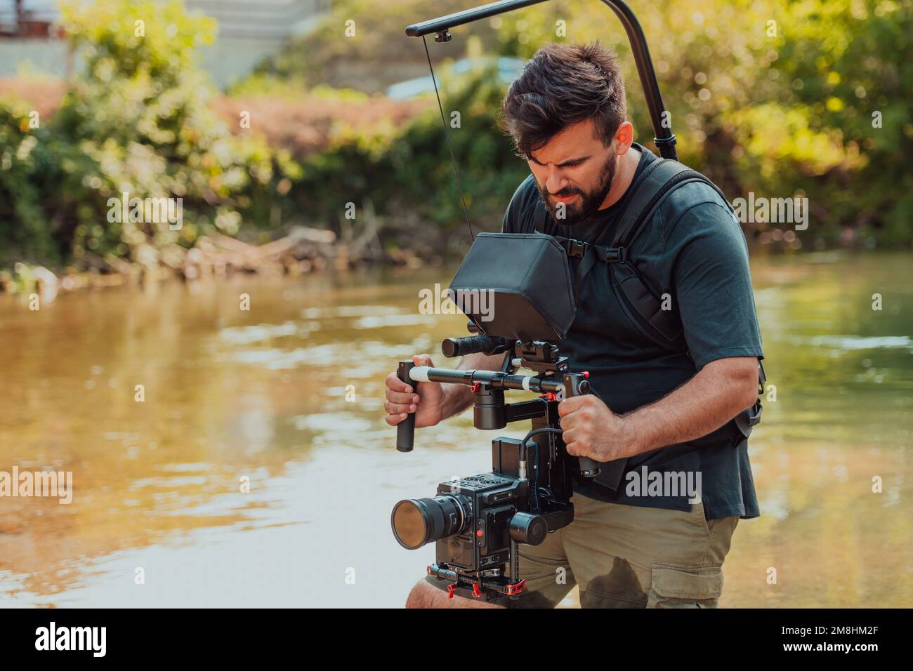 a professionally equipped cameraman shoots in the water surrounded by ...