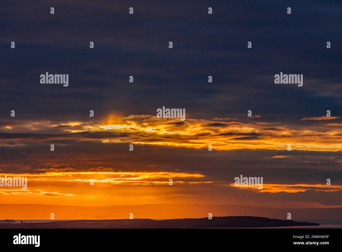 The setting sun lighting up the cloud cover Stock Photo - Alamy