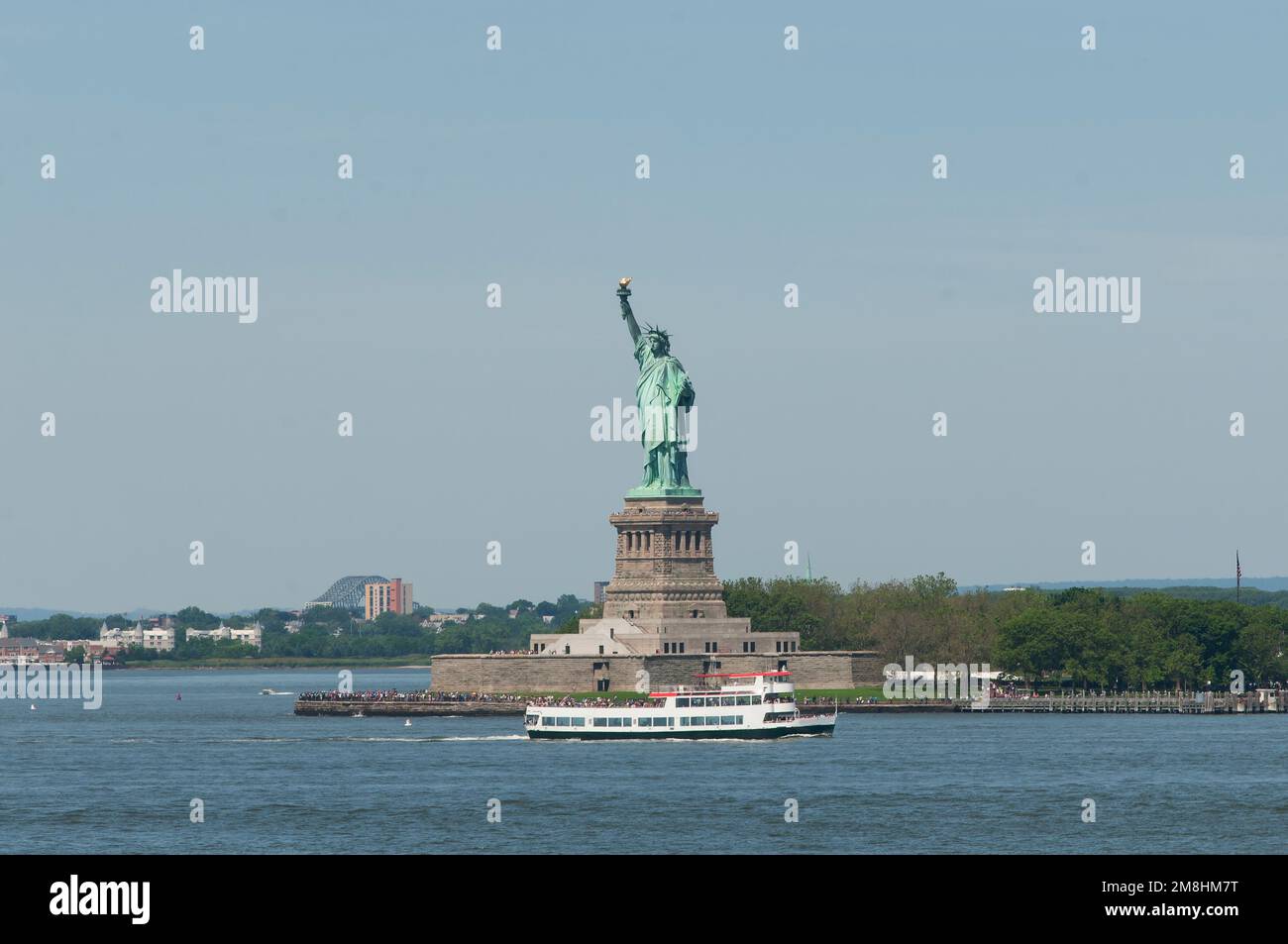 a ferry boat on the hudson river traveling by the iconic landmark ...