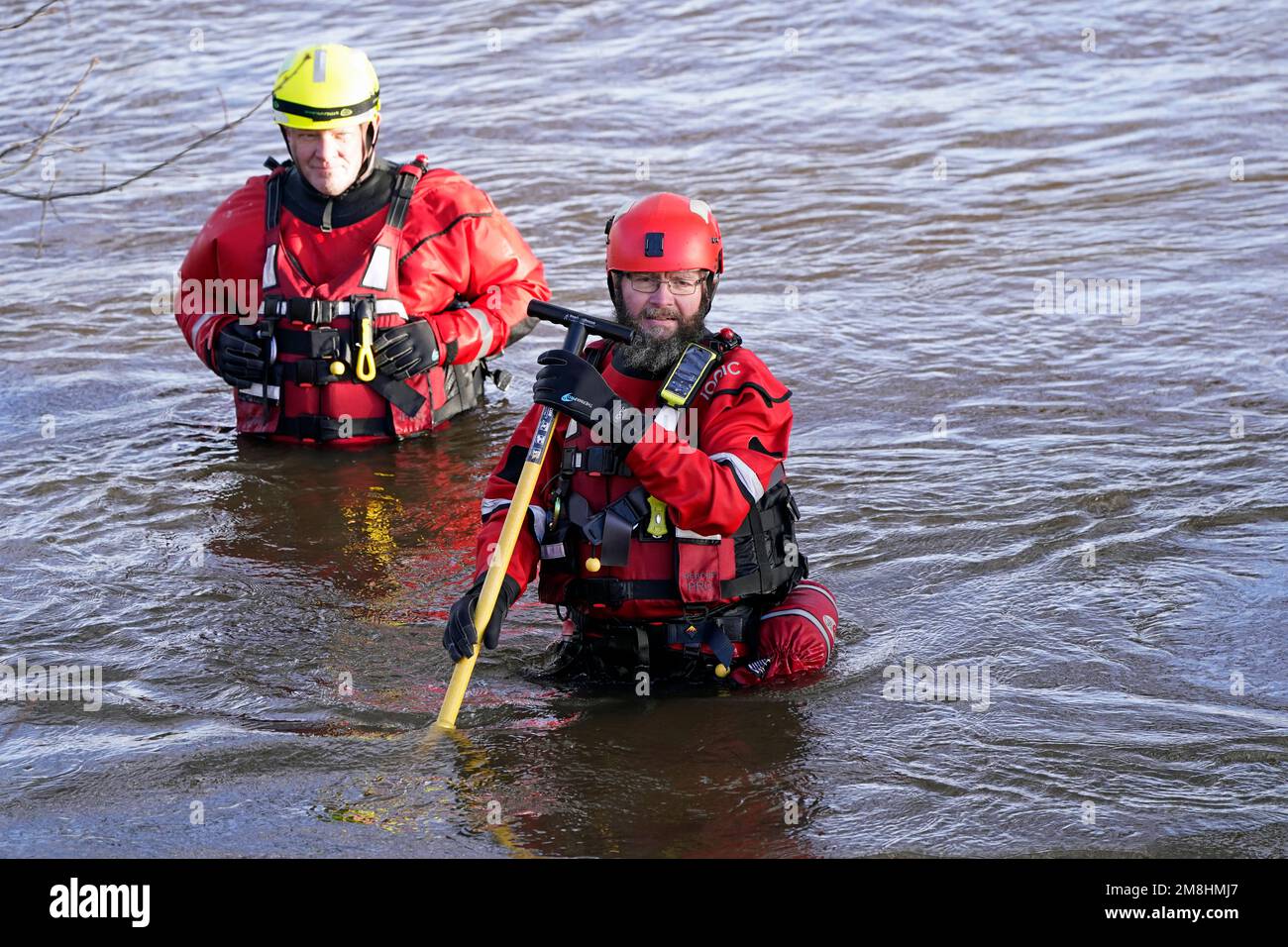Rescue workers wade through floodwater in the centre of York after the ...