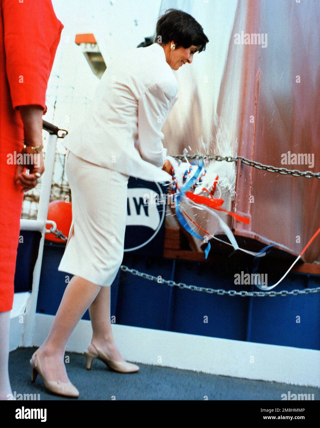 Mrs. Barbara Pope, ship's sponsor, breaks the traditional bottle of ...