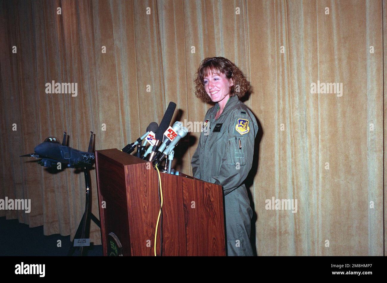 A side view of 1ST LT. Jeannie Flynn talking at the podium during a ...