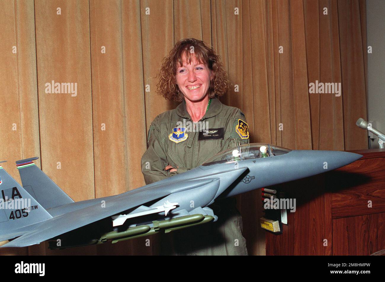 1ST LT. Jeannie Flynn poses behind a model of an F-15E Strike Eagle ...