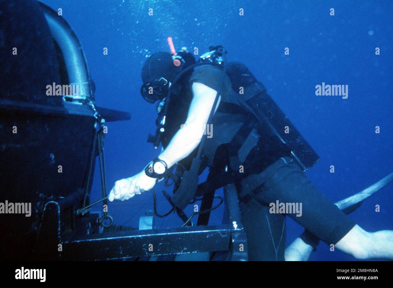 A Navy SEAL Team 2 checks the safety attachments on a Mark 8 SEAL ...