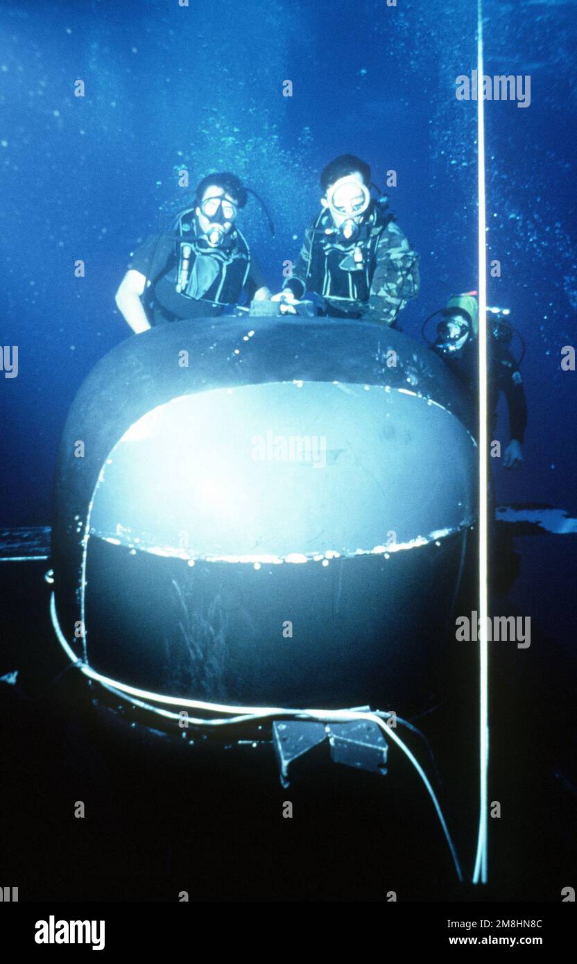 A Mark 8 SEAL Delivery Vehicle (SDV) is piloted by two Navy SEALs of ...