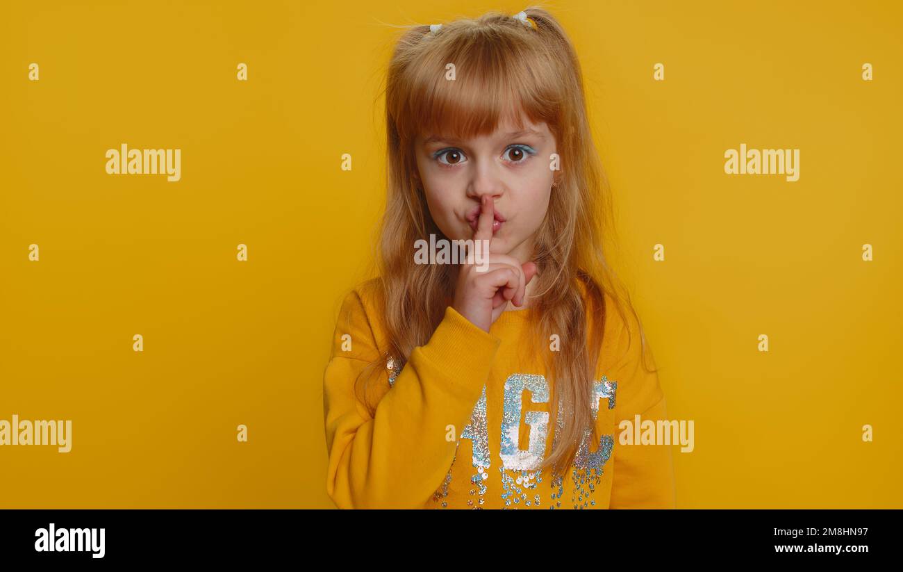 Shh be quiet please. Preteen child girl kid presses index finger to ...