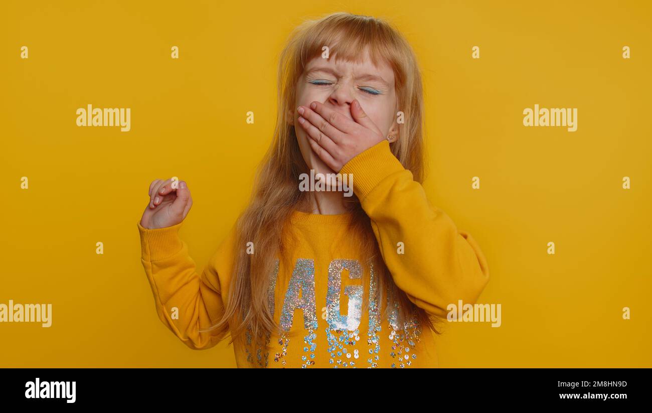 Young preteen child girl kid yawning, sleepy inattentive feeling ...