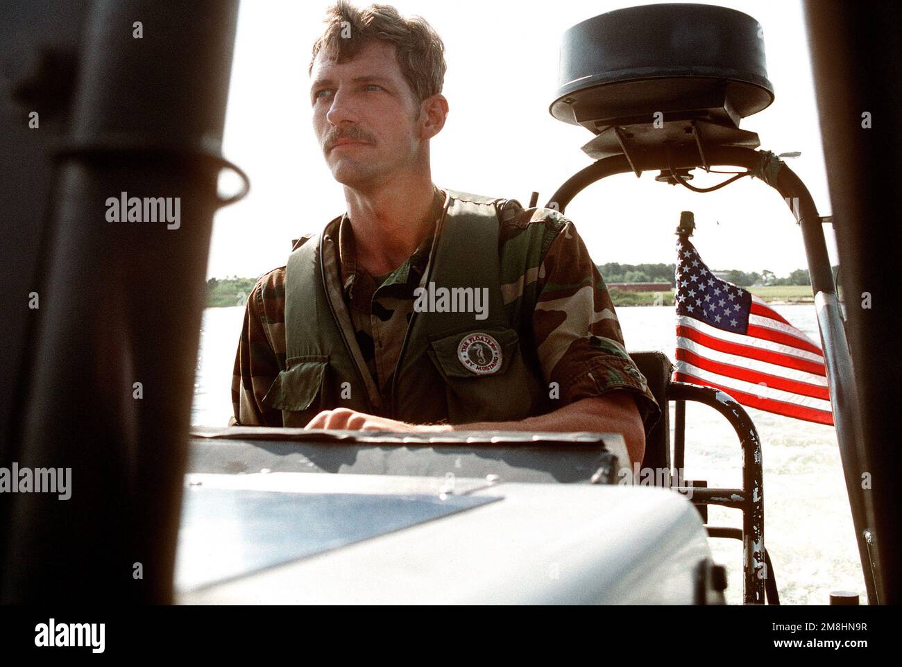 A rigid-hulled inflatable boat (RIB) is piloted by Engineman First ...