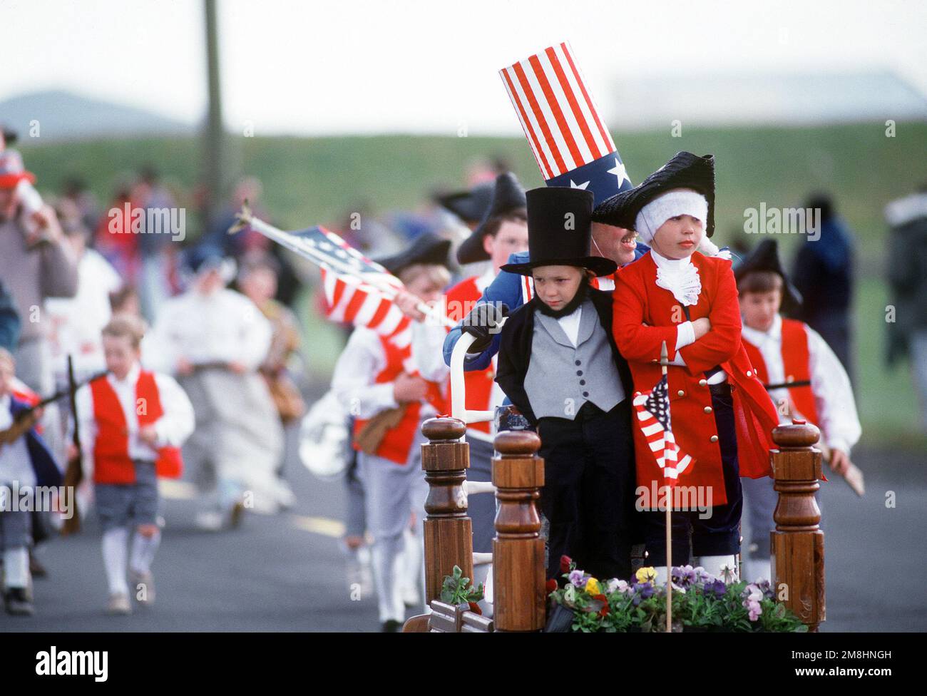 Children ride on a parade float during the air station's summer ...
