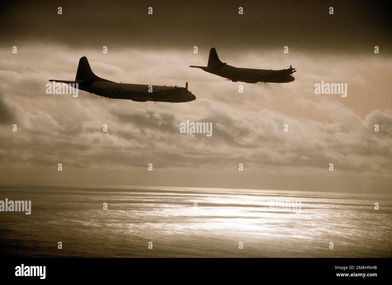 An air-to-air right side view of a pair of P-3C Orion aircraft from ...