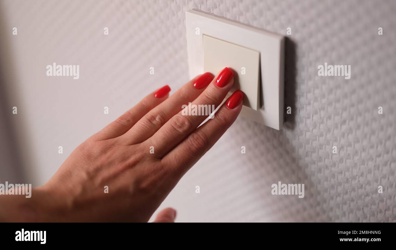 Womans hand light switch hi-res stock photography and images - Alamy