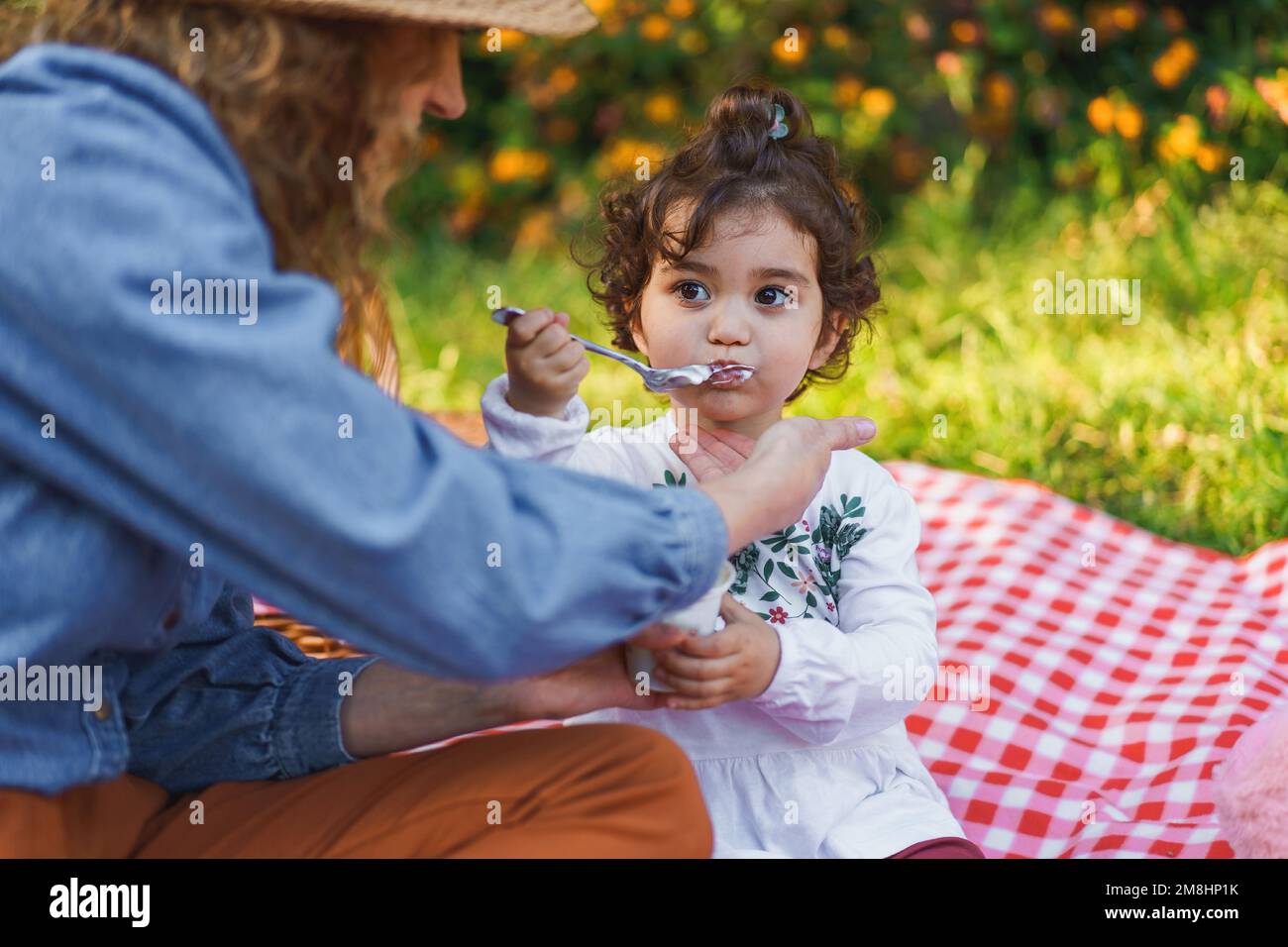 A close-up shot of a young 2-year-old Brazilian girl with fair skin ...