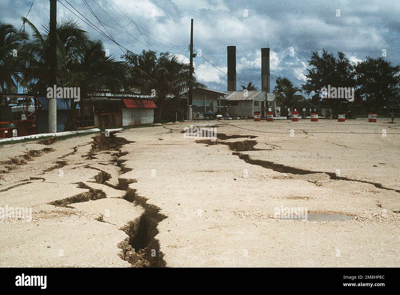 Cracks run through a parking lot in the aftermath of an earthquake that ...