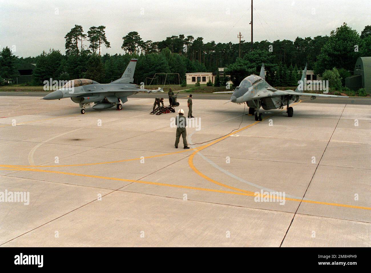 German MIG-29 (right) next to U.S. Air Force F-16 parked on the ...